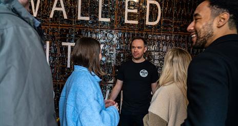 Group listening to the guide while enjoying the Beer Masterclass at the Walled City Brewery in Derry~Londondonderry