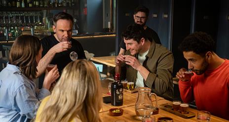 Group smelling the beer samples and enjoying the Beer Masterclass at the Walled City Brewery in Derry~Londondonderry
