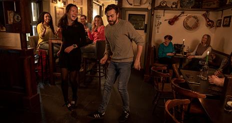 Man joining in with Irish dancing as part of the Ceili & Craic experience at The Ponderosa.