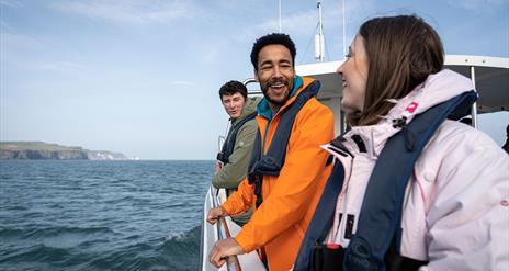 Group on a boat wearing lifejackets as part of a scuba diving experience with Aquaholics 